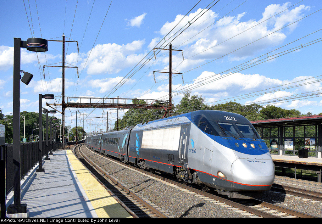 Westbound Amtrak Acela passing Metropark Station