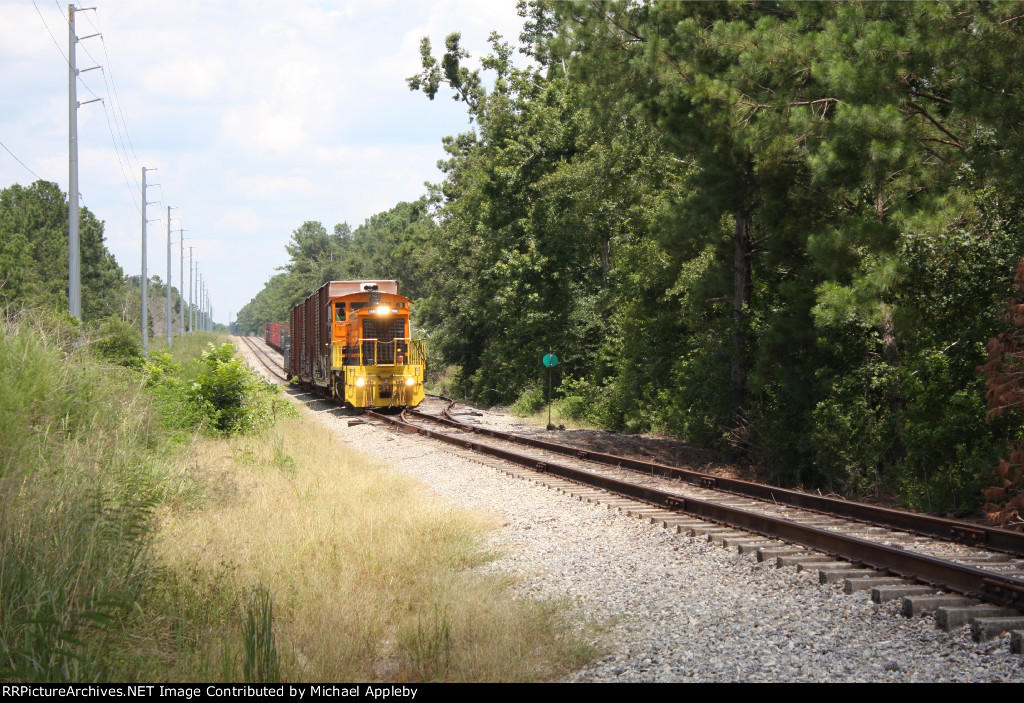 CIRR 1555 leads the train past storage cars.