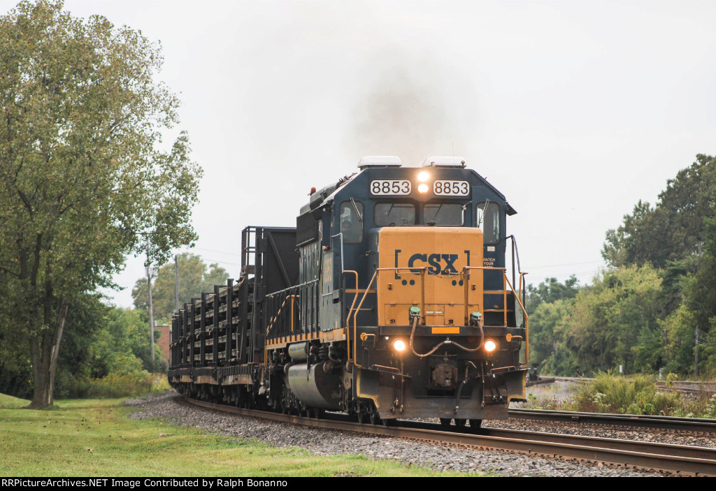 Ex-Conrail SD40-2 leads a rail train eastbound through town