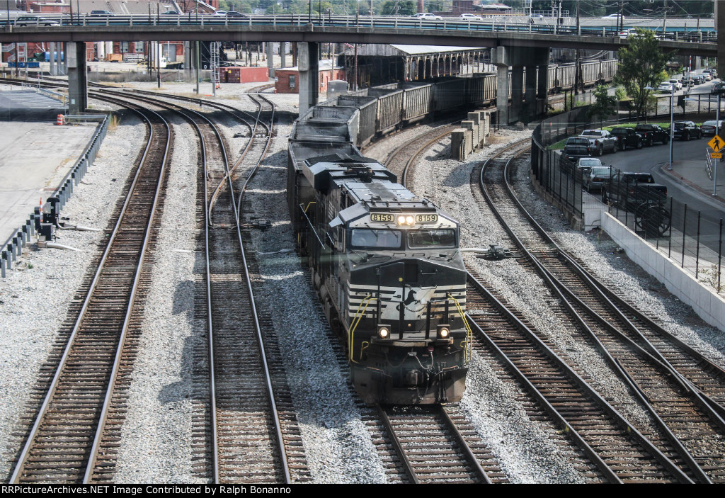 NS 8159 leads empty hopper train 811 through town