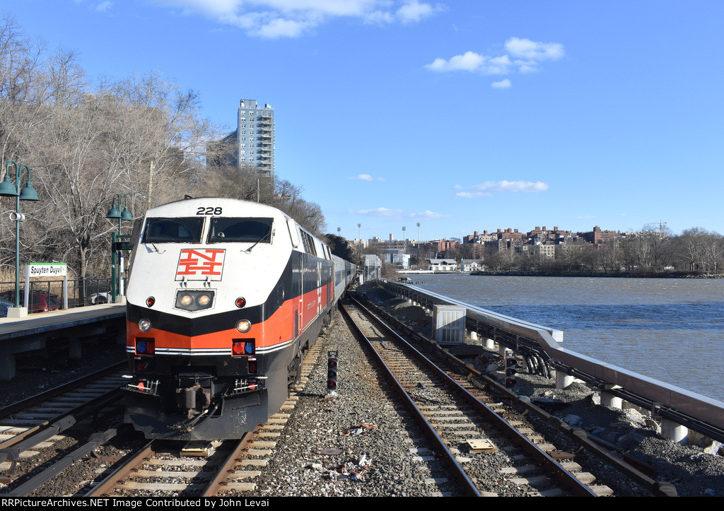 CDOT P32AC-DM # 228 leads northbound MNR Train # 847 past the station