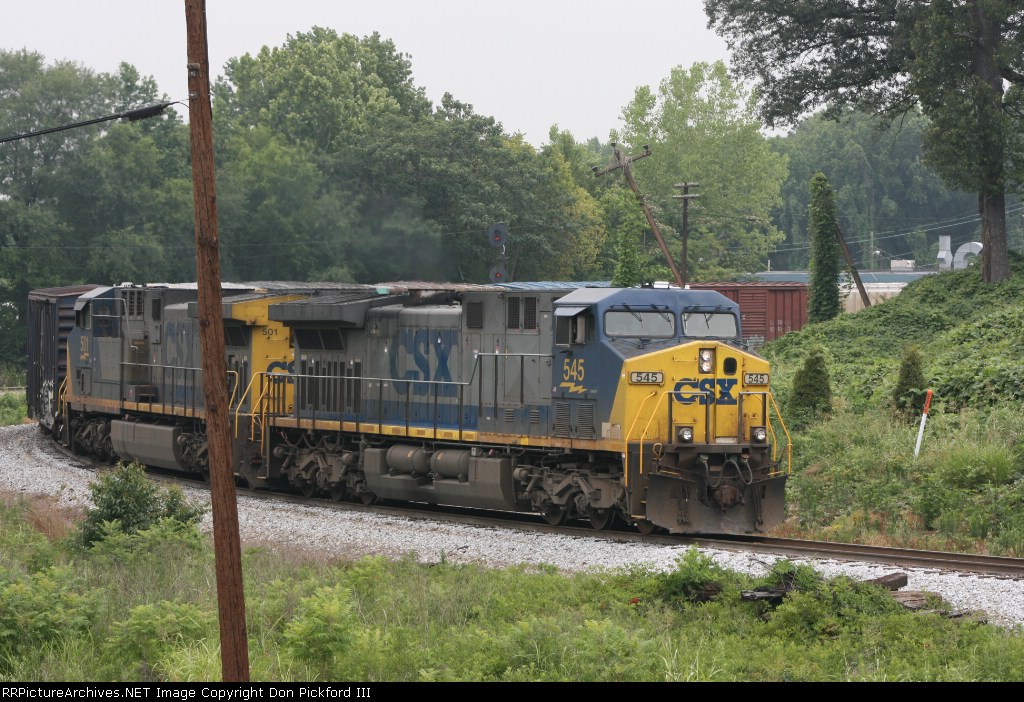 CSX 545 (AC4400CW) mixed freight pulls to a stop prior to the diamond