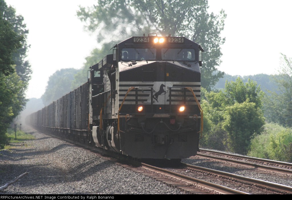Westbound empty hopper train approaches from the east on track 1