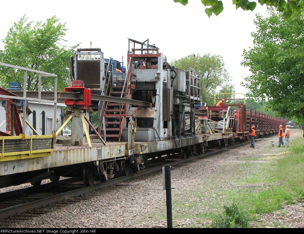 080604020 Eastbound BNSF ribbonrail train holds the main to reclaim used rail between Wayzata ...
