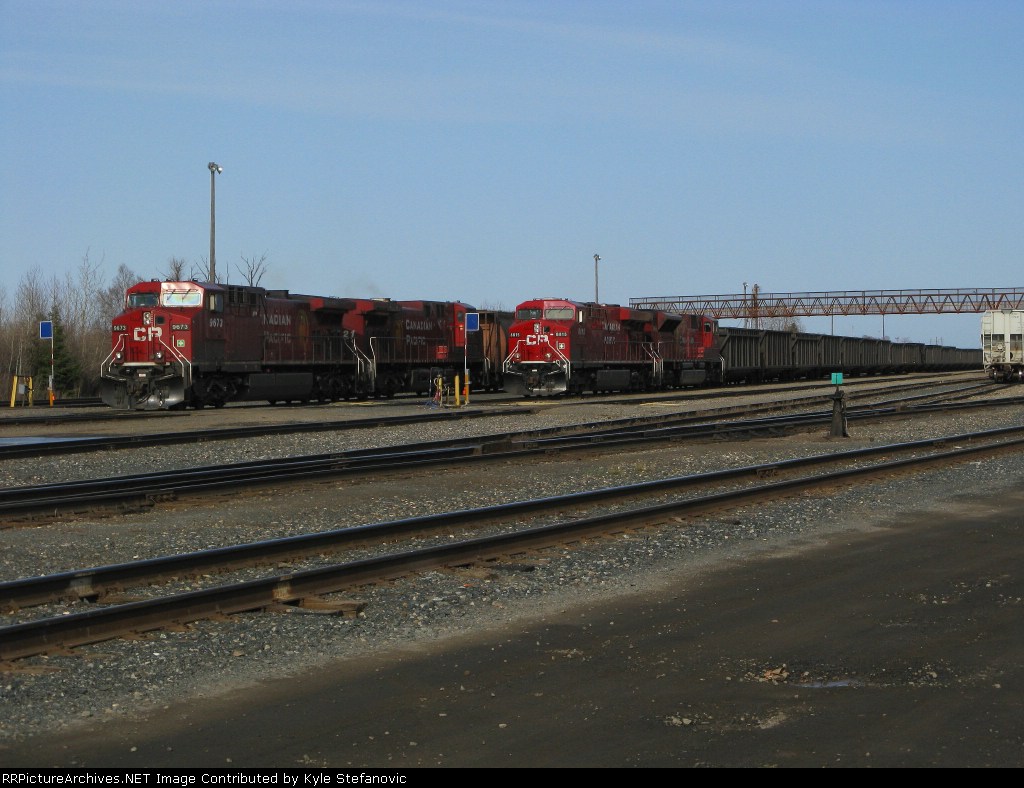 Power for a westbound empty grain train and coal train sit in Westfort Yard
