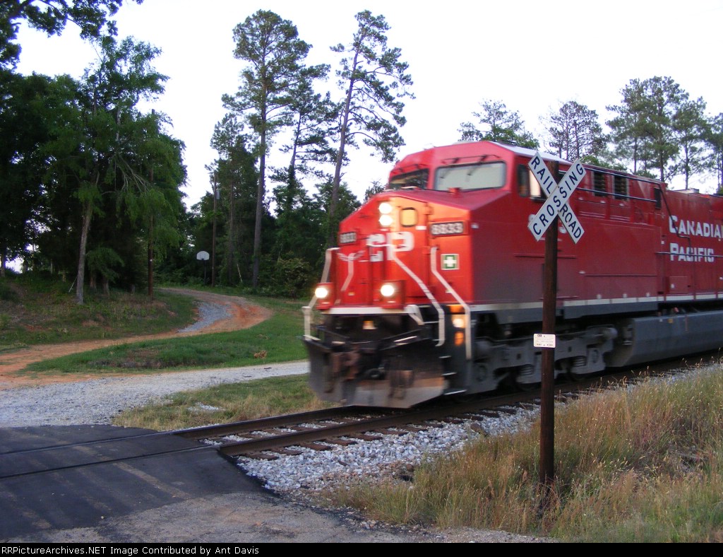 CP 8833 blurs past a private crossing
