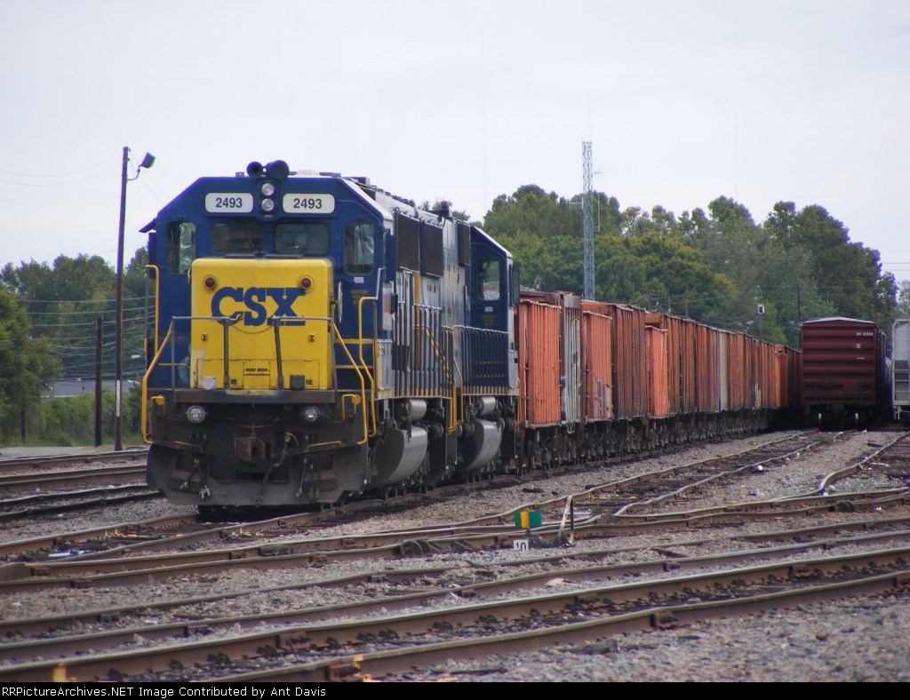 CSX 2493 sits in the Yard with a string of empty rock hoppers