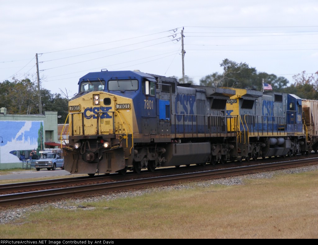 CSX 7801 passing the unfinished mural (left)