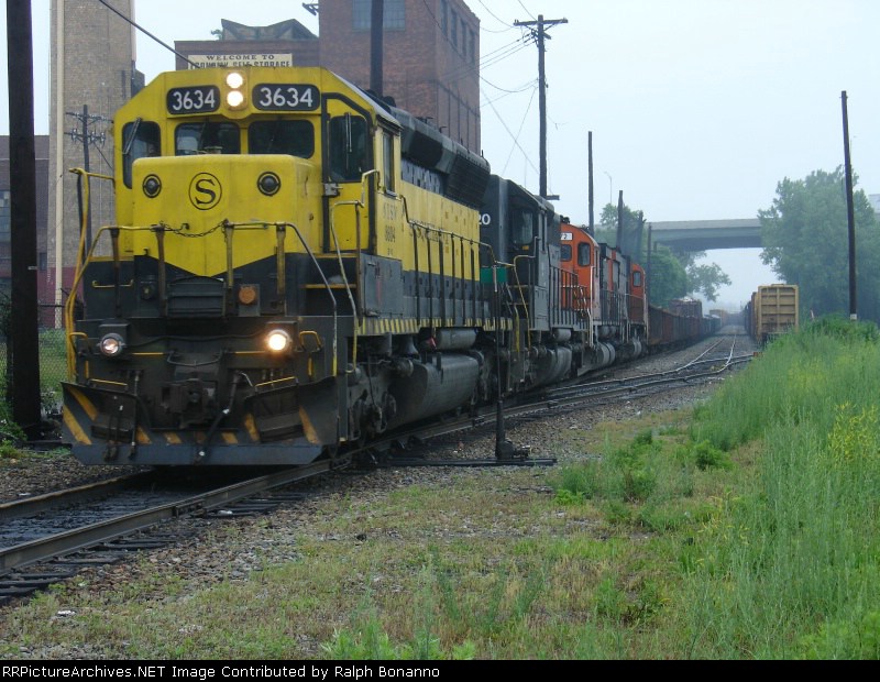 SU-99 about to cross Cross Street, and leave yard limits