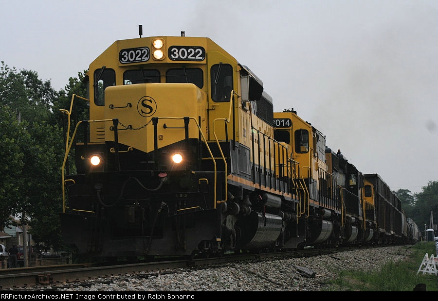 NYS&W road train SU-99 rolls west thru town enroute to Binghamton NY under threatening skies ...