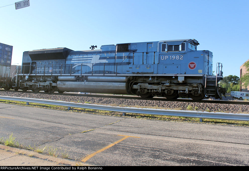 UP -Missouri pacifi heritage unit as a DPU on an eastbound stack train during the morning rush hour