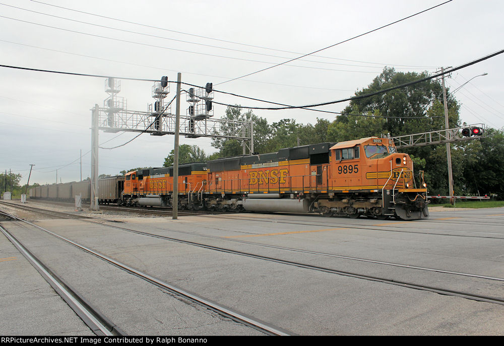 A pair of BNSF SD70MAC's lead a coal train across Lincoln Ave on an over cast afternoon