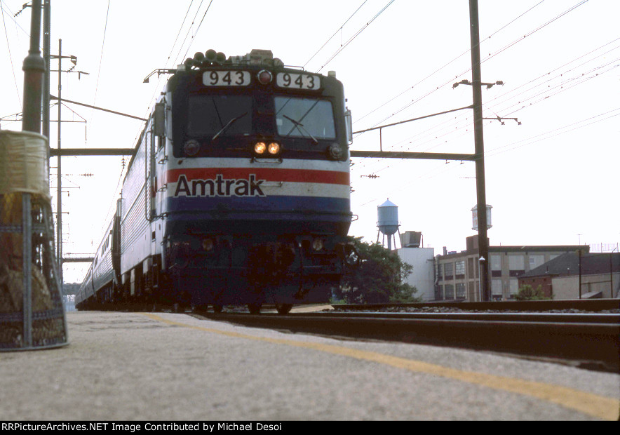 Amtrak AEM-7 #943 speeds east thorugh the Frankford Junction station on ...