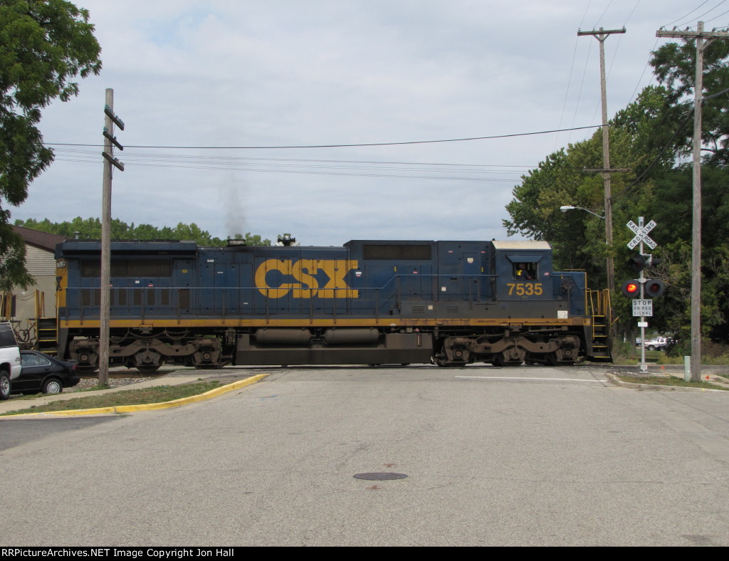 With D700 tied back together, CSX 7535 rolls east across the Broadway Ave crossing