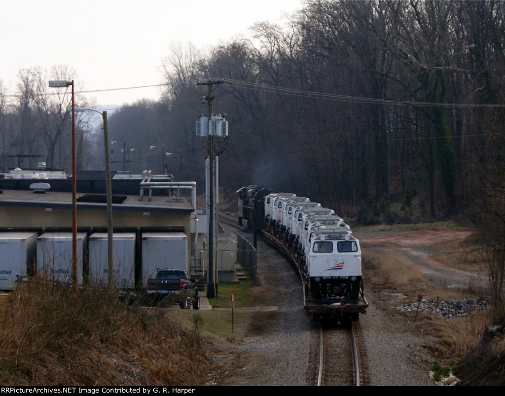 NS train 098 with dual-cab export units for Norfolk head south passing Flowers Baking.