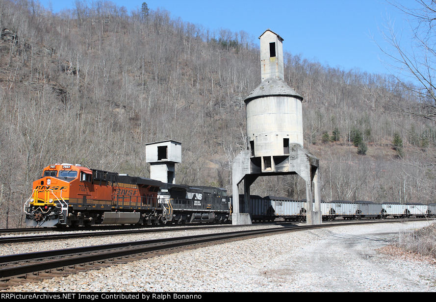 An eastbound coal train led by BNSF 7027 passes the coal tower at "farm"
