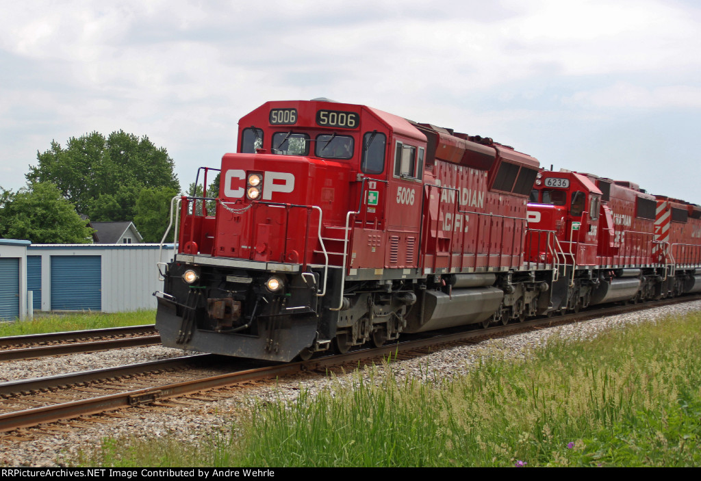 CP 5006 flies through leading an all-red, all standard cab EMD lashup on 633