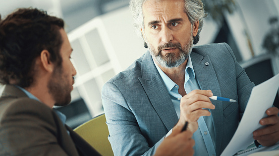 Closeup side view of a middle-aged male business leader meeting with an ...