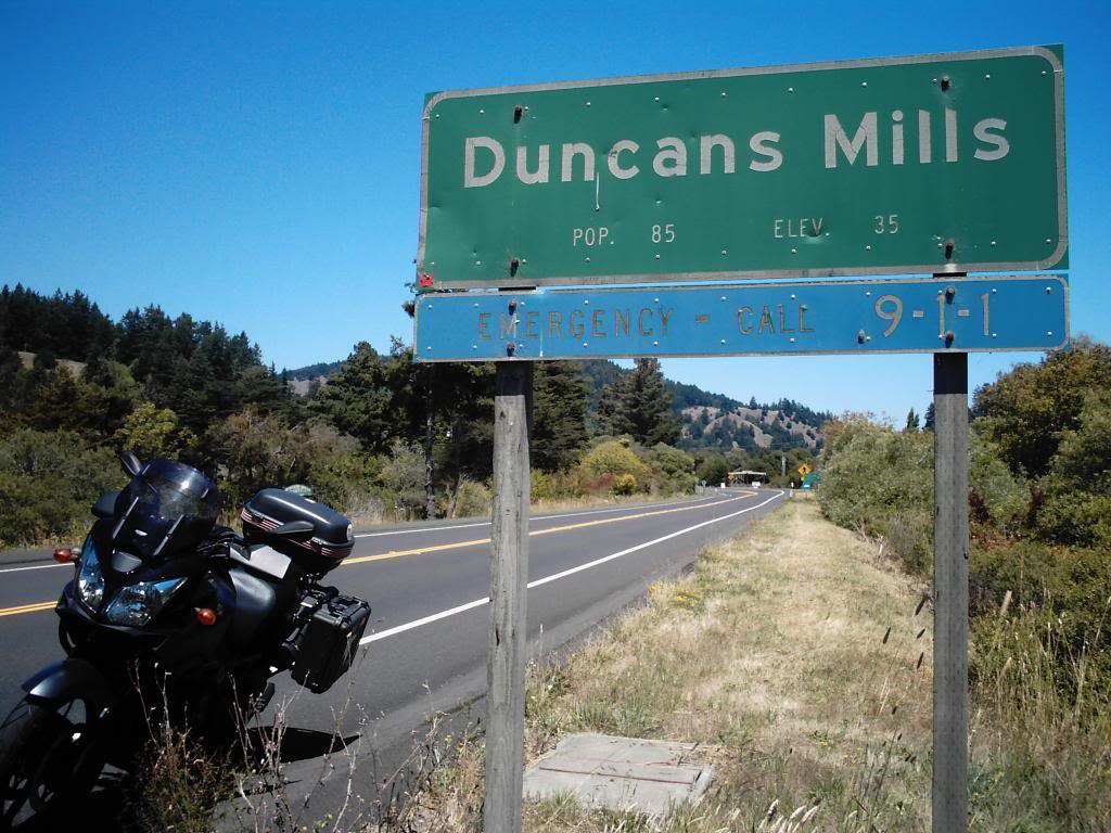 your bike and a small town population sign | Adventure Rider