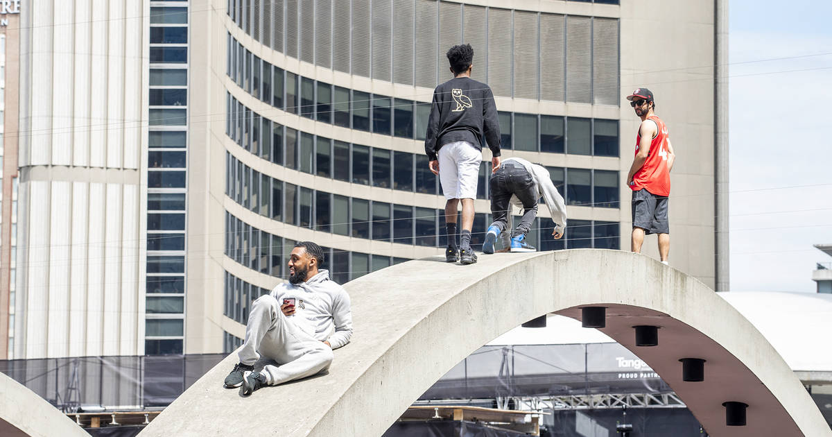 Fans climbed the arches at Nathan Phillips Square to view the Raptors party