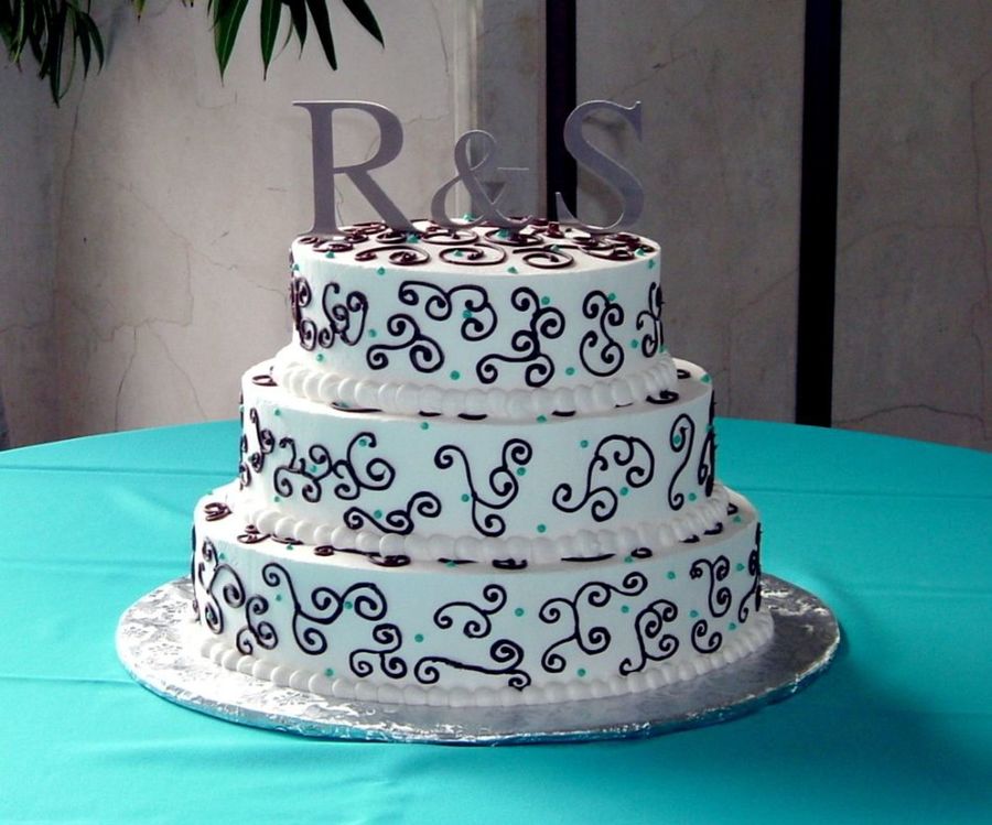 Oval Buttercream Cake With Chocolate Truffle Scrolls And Teal Buttercream Dots - CakeCentral.com