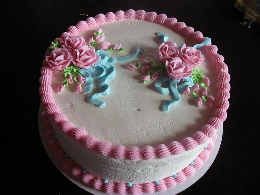 Round Cake With Blue Ribbons And Pink Flowers - CakeCentral.com