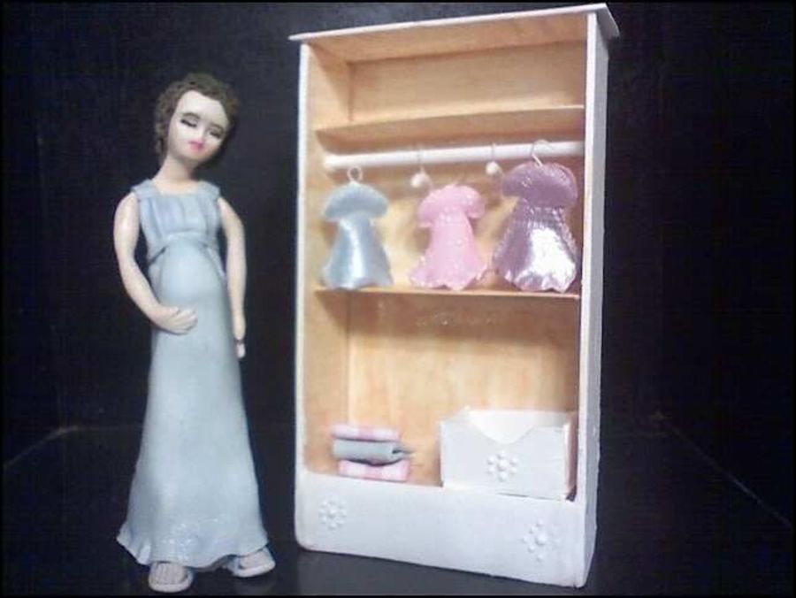Gumpaste Pregnant Woman With Wardrobe And Dresses - CakeCentral.com