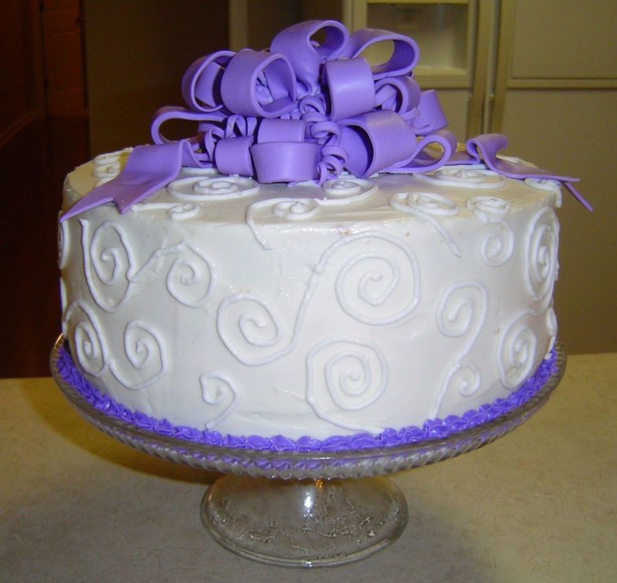 White Cake With Swirls And Purple Bow - CakeCentral.com
