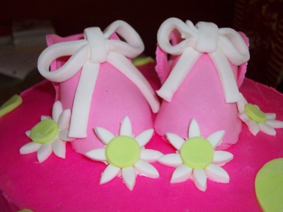 Pink Buttercream Cake With Green Accents And Pink Fondant Baby Booties ...