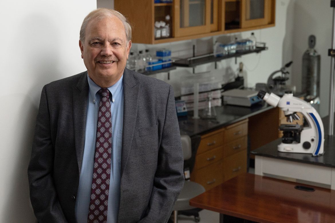 Photo | Dennis Slamon — waist-up shot in coat and tie with microscope ...