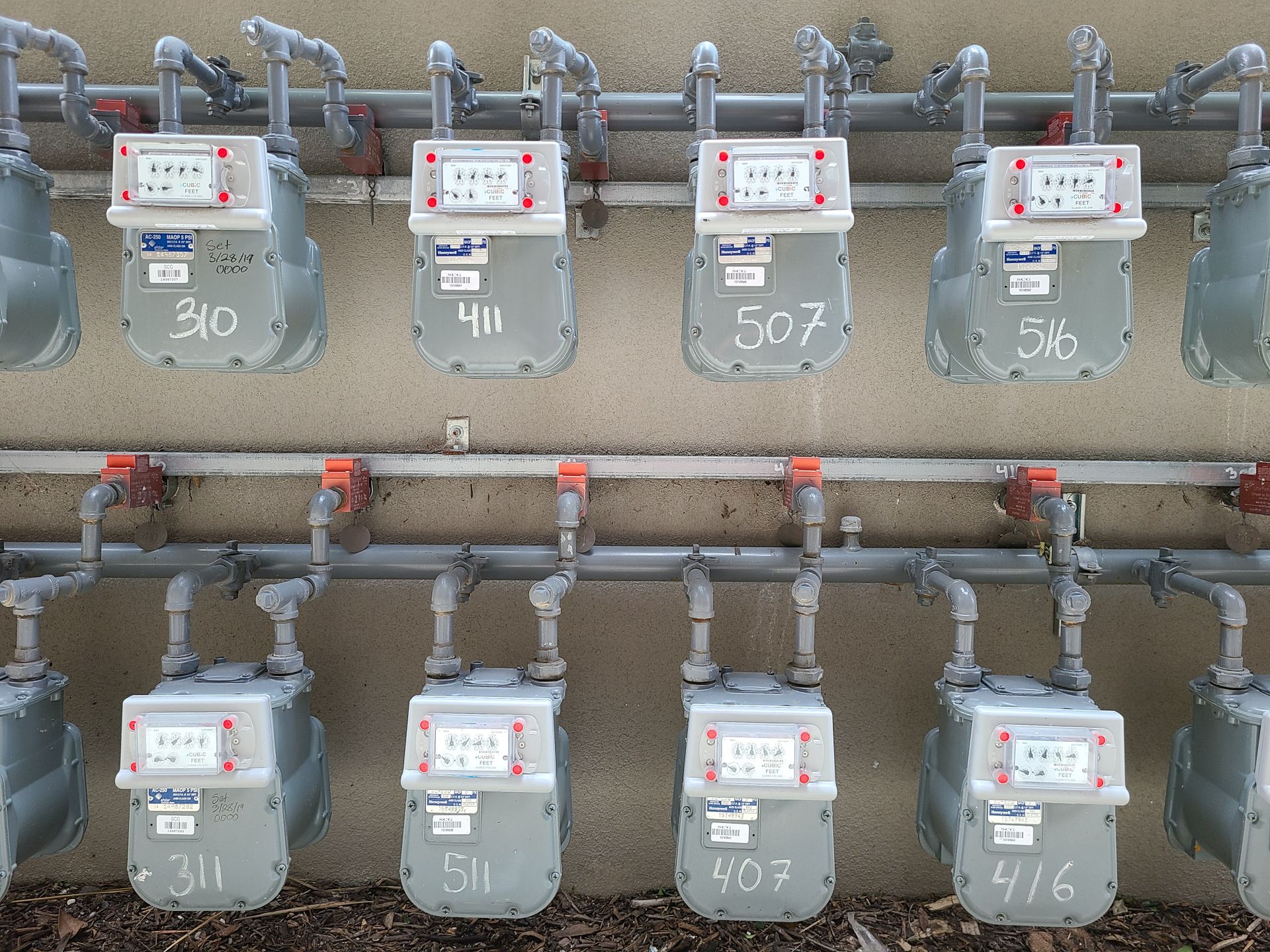 Photo | Two rows of utility meters outside of a residential building | UCLA