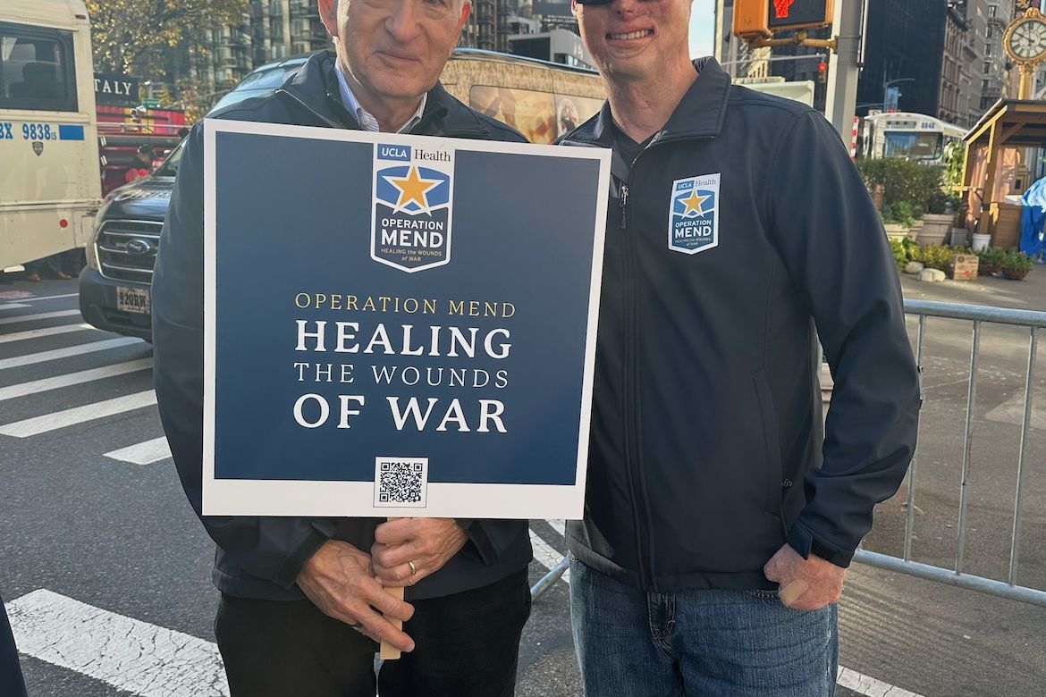 Photo | Chancellor Block, holding sign, stands with patient of ...