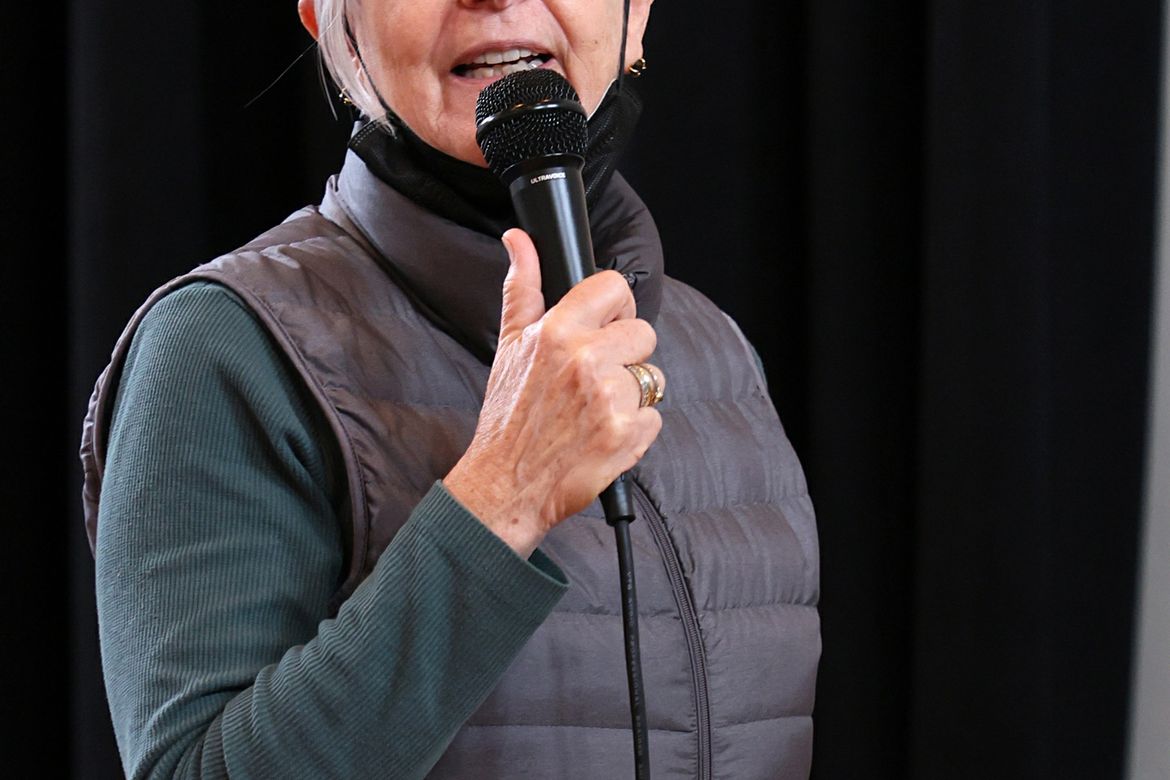 Photo | Victoria Marks wearing a puffer vest and speaking into a ...