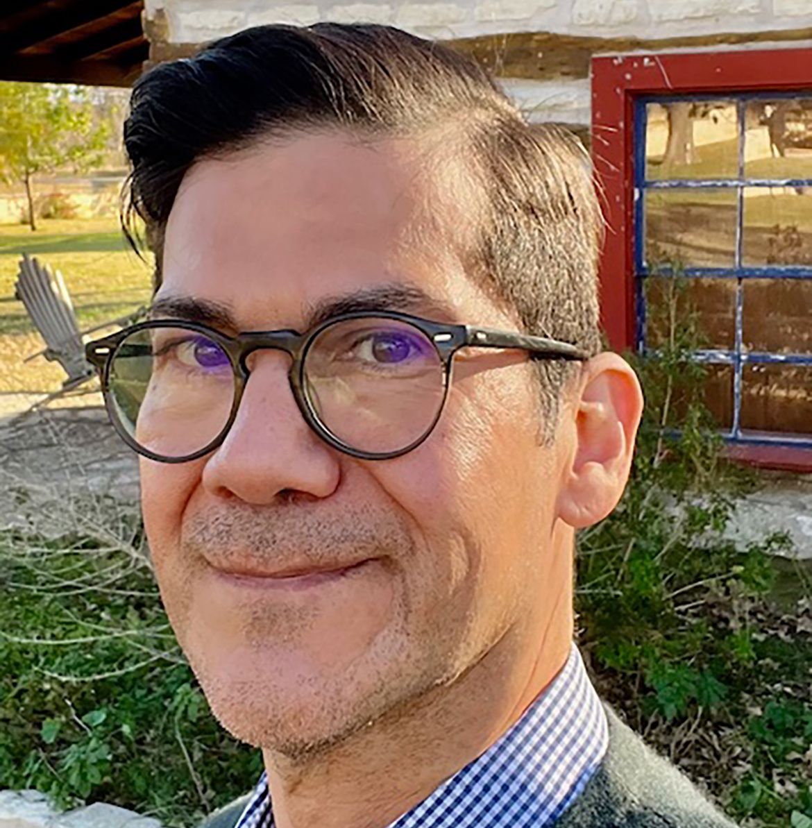 Photo | Randall Espinoza wearing green sweater and glasses | UCLA