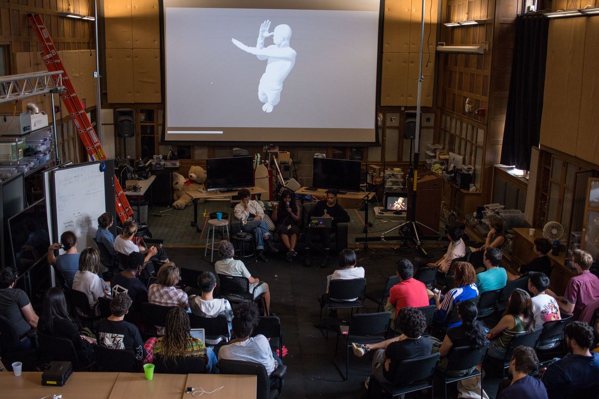 Photo | Conference attendees watching humanlike figure on an overhead ...