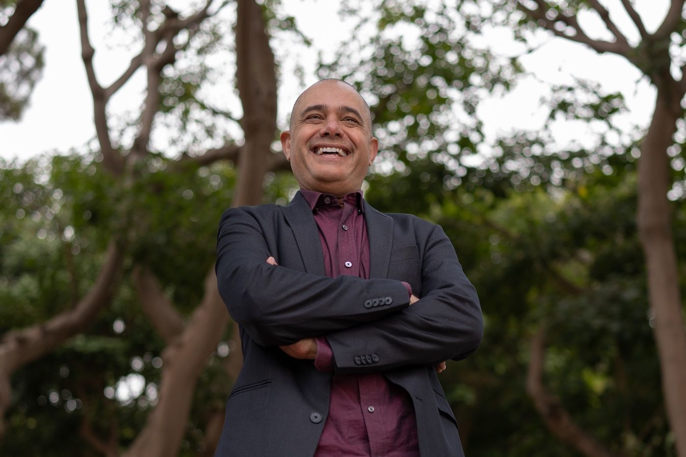 Photo | Lionel Popkin stands with arms crossed, with trees in backround ...