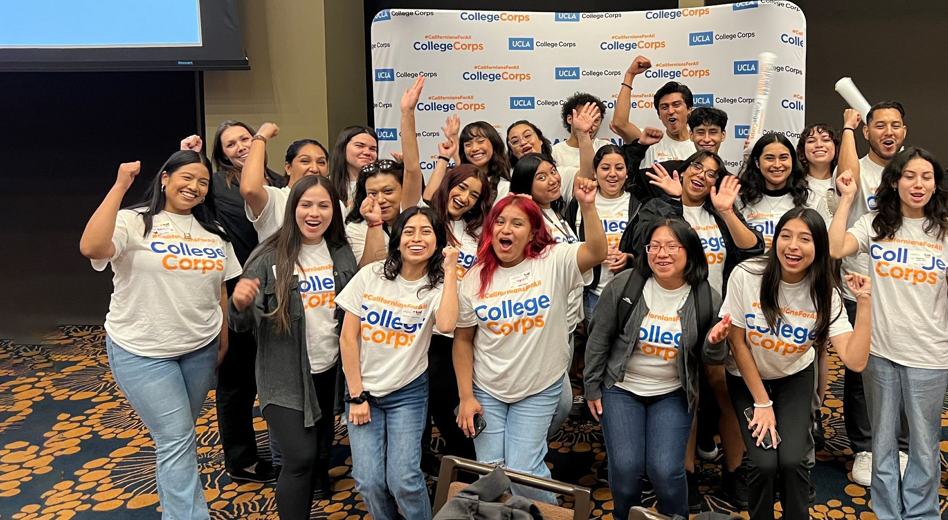 Photo | A group of students in UCLA College Corps shirts cheer in front ...