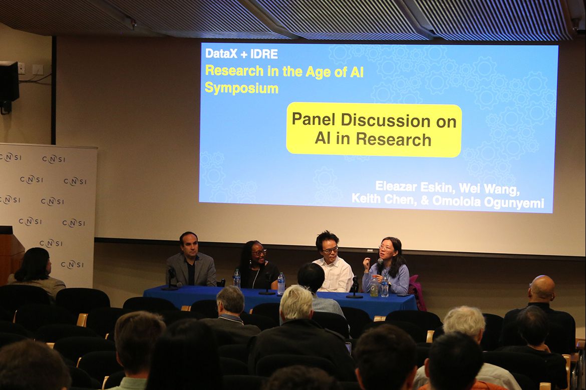 Photo | Panel speakers at table in front of screen with “Panel ...