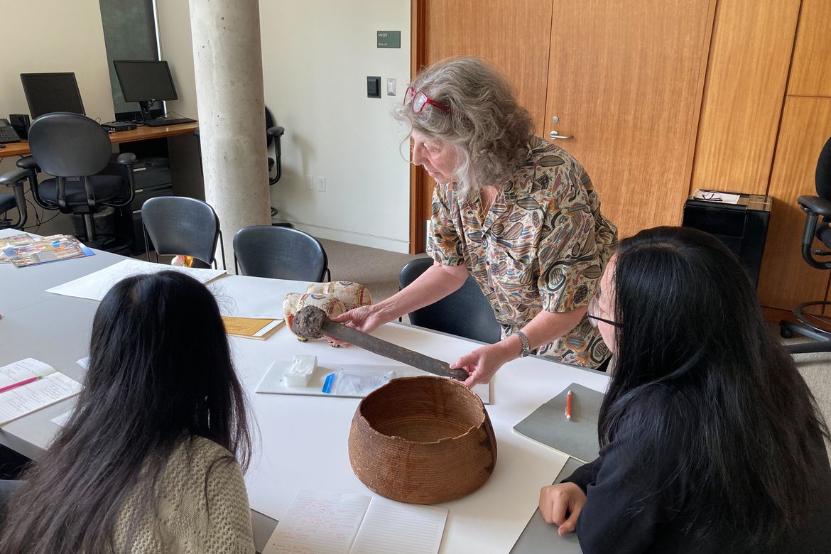 Photo | Ellen Pearlstein holding object while teaching | UCLA