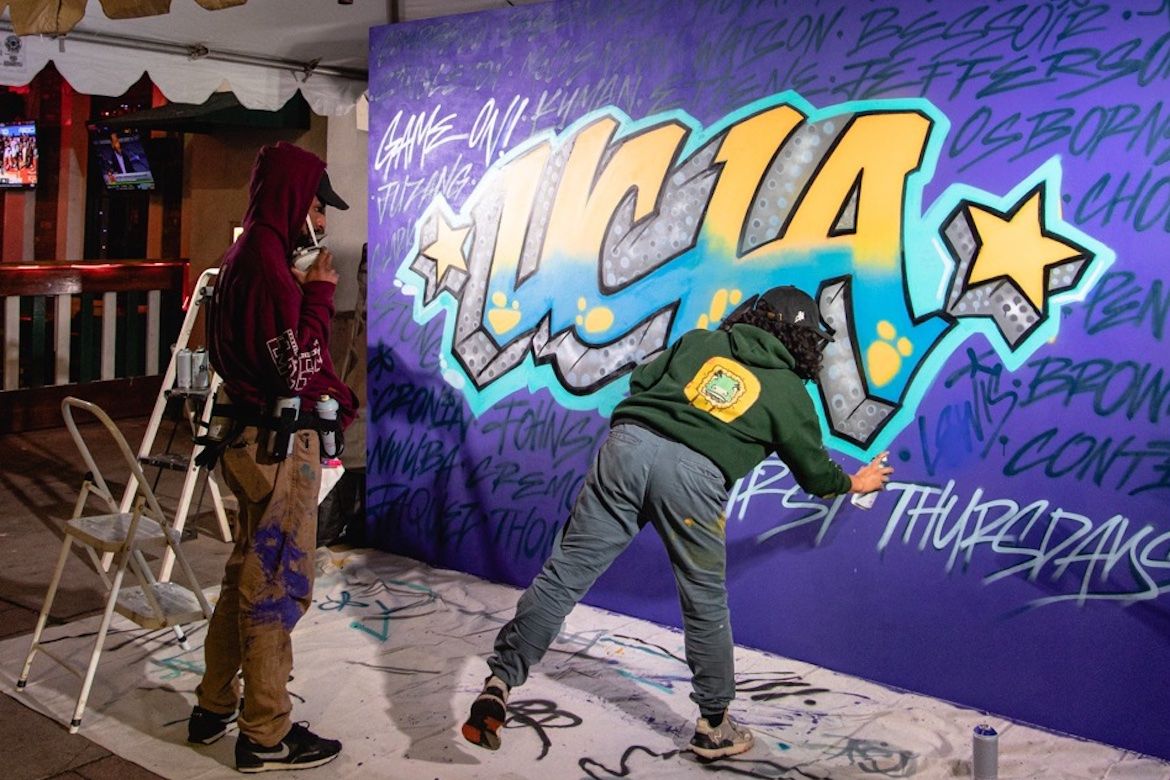 Photo | Lily Breeze, right, painting a graffiti mural | UCLA