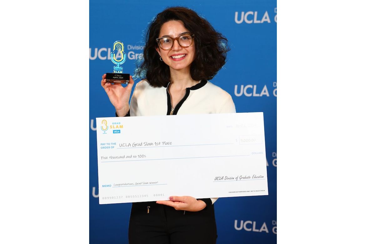 Photo | Melis Cakar with award and check | UCLA