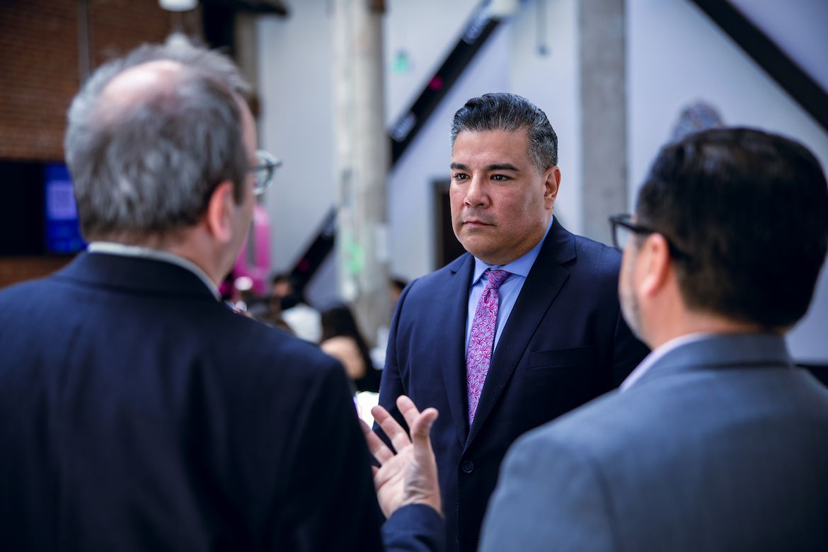 Photo | California Insurance Commissioner Ricardo Lara speaks with two attendees at the policy ...