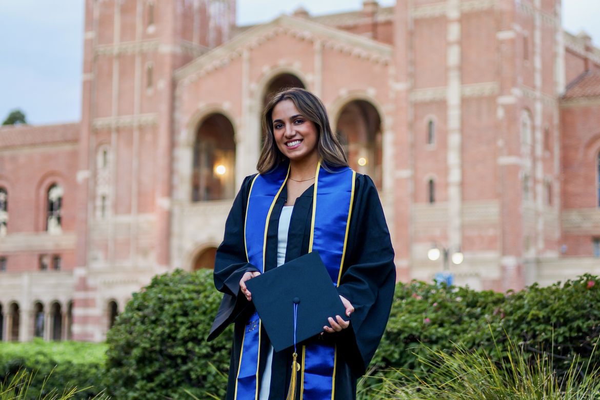 Photo | Eva Danesh wearing graduation gown and holding cap | UCLA