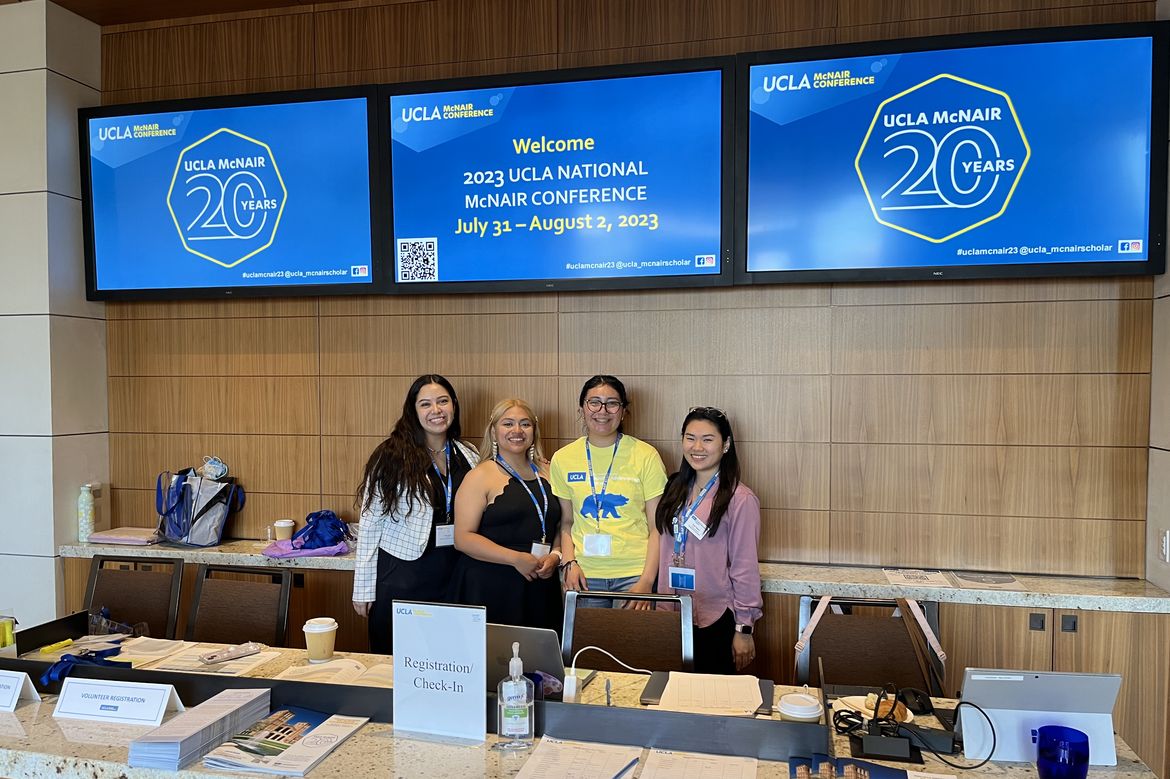 Photo | Four people stand below screen with 2023 UCLA National McNair ...