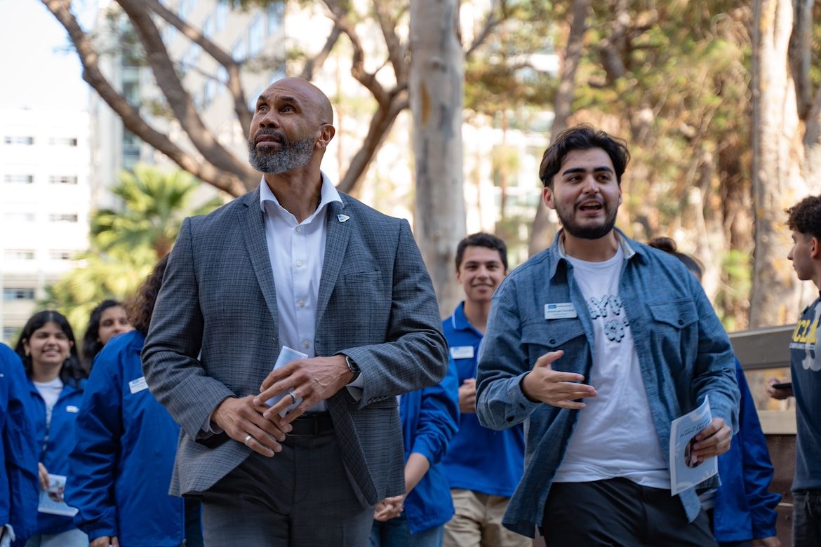 Photo | Darnell Hunt walking with students during move-in, 2024 | UCLA