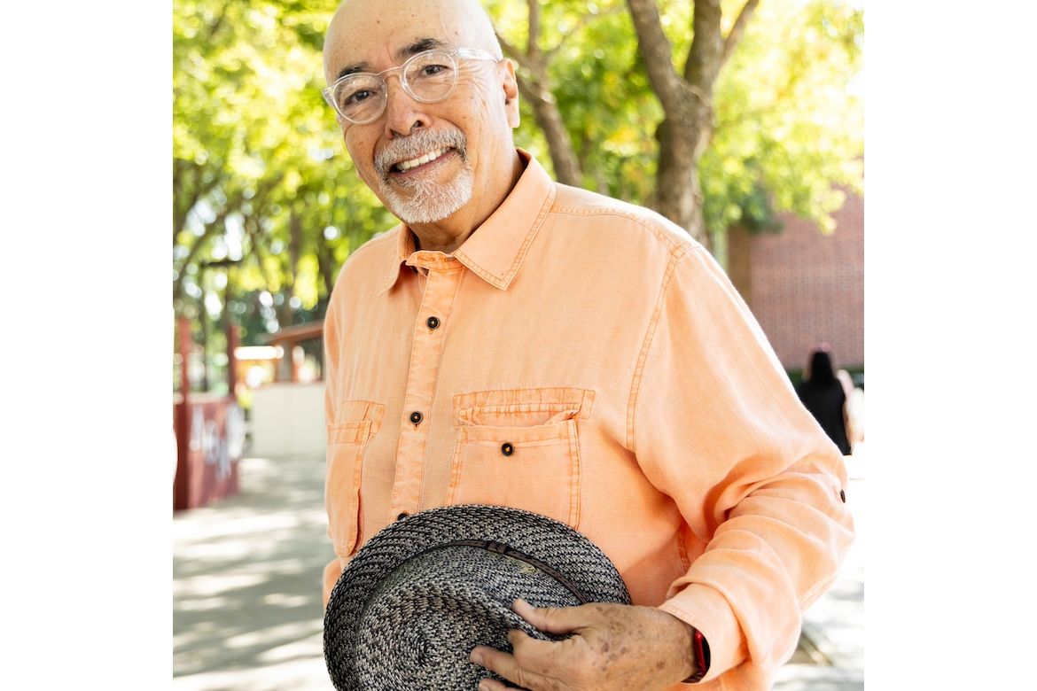 Photo | Juan Felipe Herrera in peach-colored shirt holding hat in hand ...