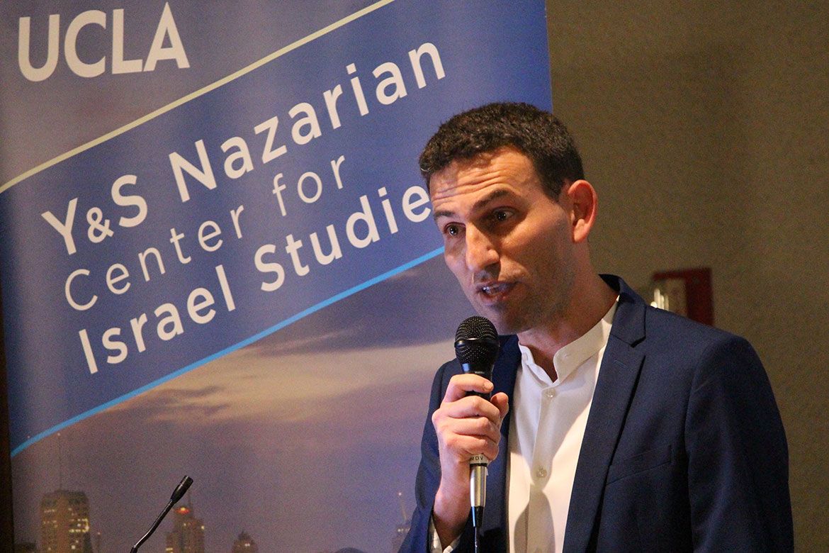 Photo | Close-up of Rami Hod speaking into a microphone | UCLA