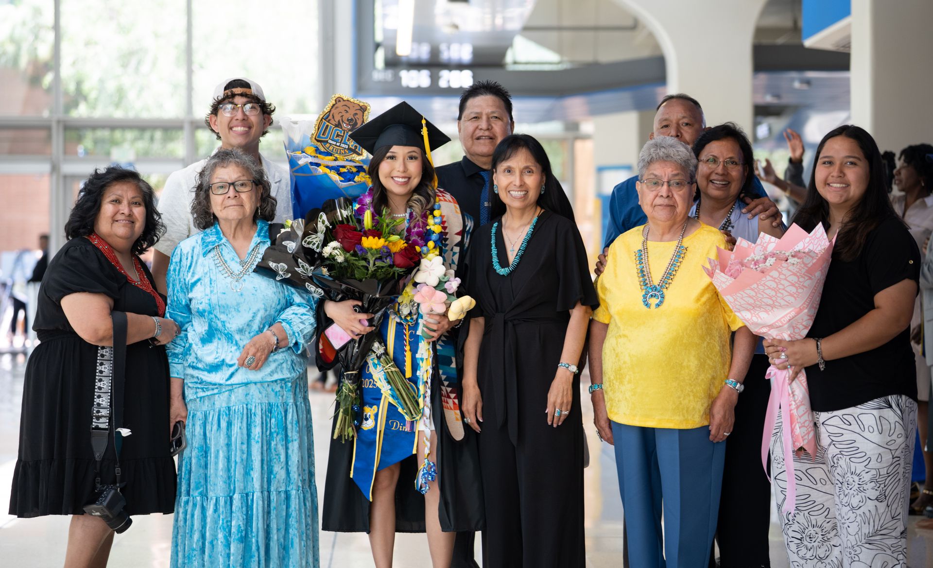 Photo | Commencement 2025—Large family with graduate and flowers on ...