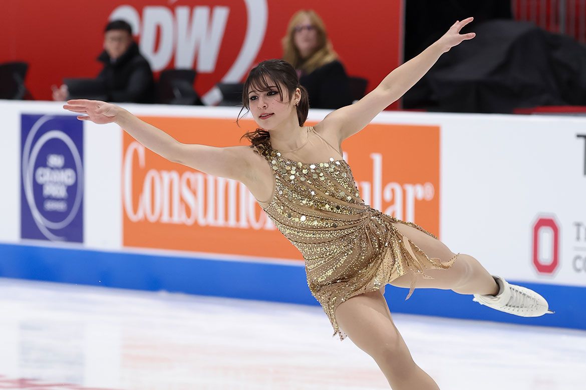 Photo | Figure skater Alyssa Liu performing on the ice in a gold ...