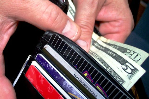 Photo | hands pull out money from wallet | AAA East Central